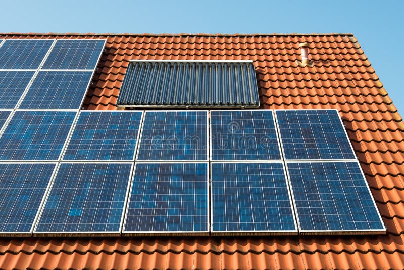 Solpanel På Ett Tak Av En Hus- Och Vindturbinsarround Fotografering för ...