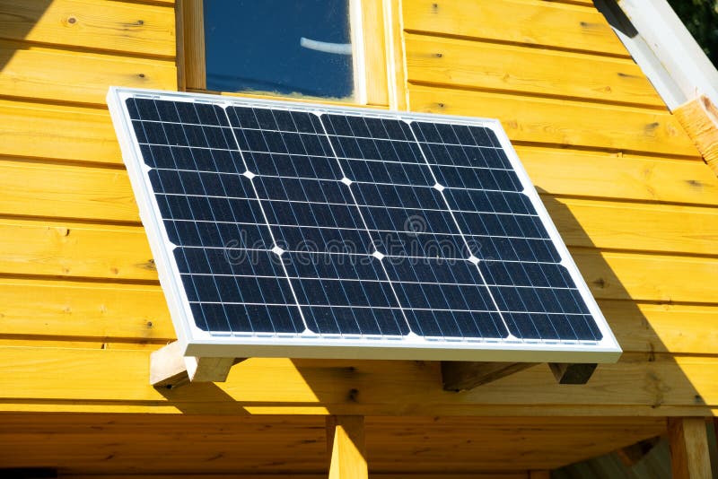 Solar Battery or Solar Panel on the Facade of a Small Wooden House or ...