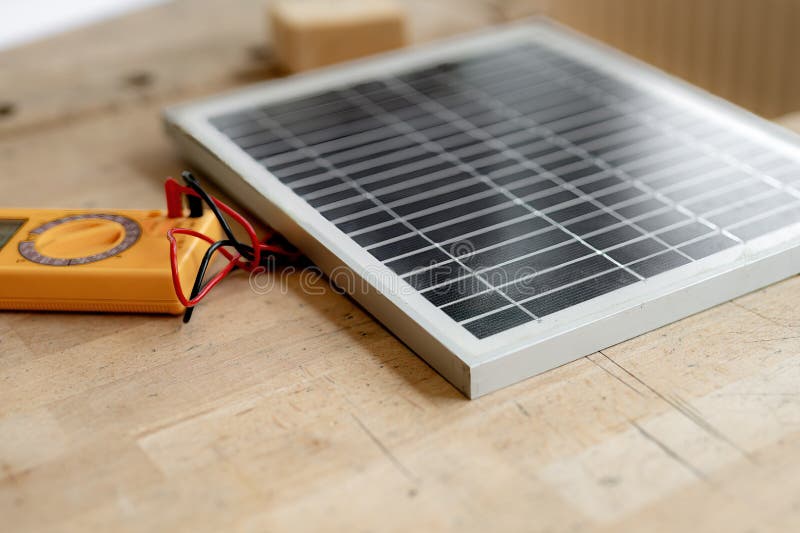 Solar Battery and Voltmeter on the Electrician S Desk. a Device for ...