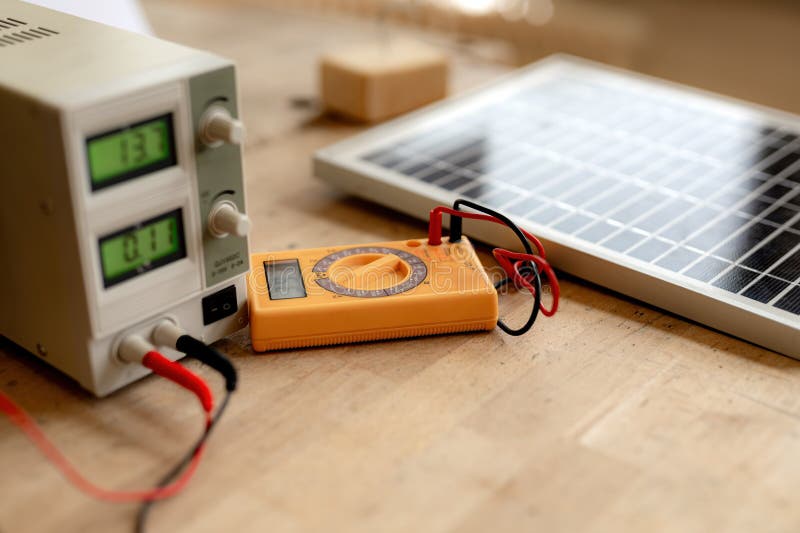 Solar Battery and Voltmeter on the Electrician S Desk. a Device for ...