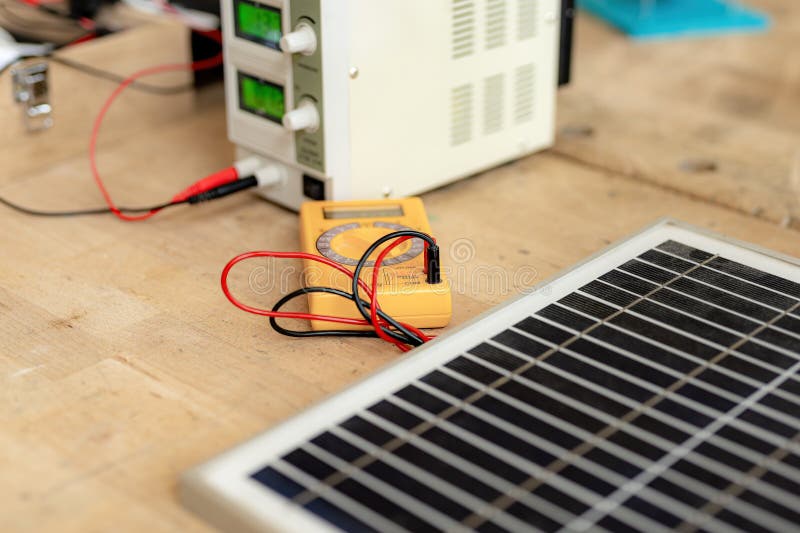 Solar Battery and Voltmeter on the Electrician S Desk. a Device for ...