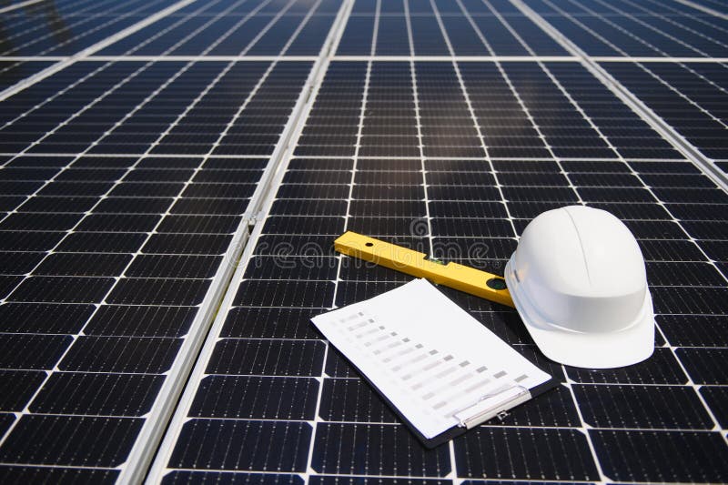 Solar Cell Contractor Document with Orange Engineering Team Helmet on ...