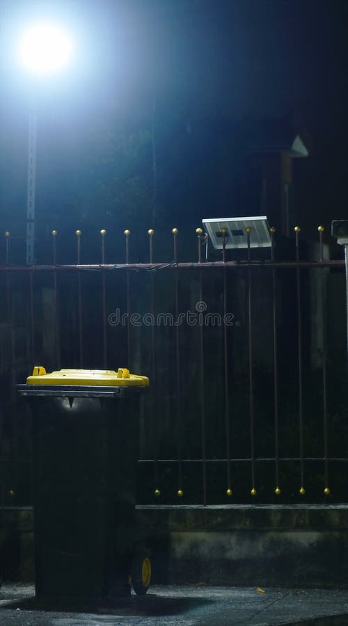 Solar Cell Lamp in Front of Home Spot To Garbage Bin in Night Stock ...