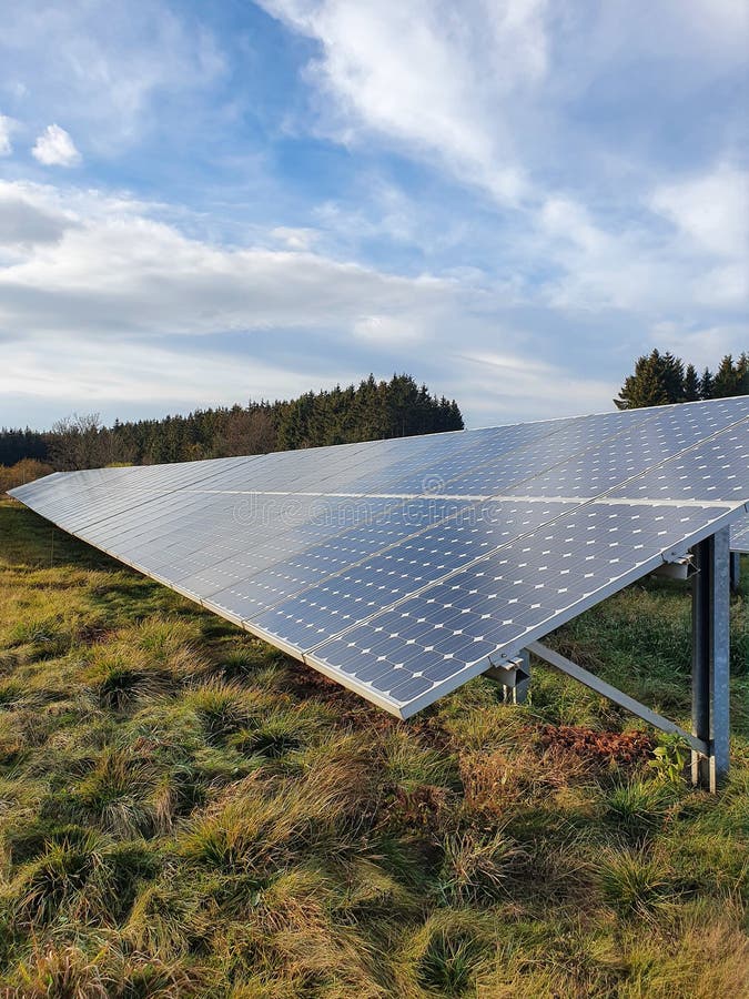 Solar Cells on a Meadow with Blue Sky with Clouds. Stock Image - Image ...