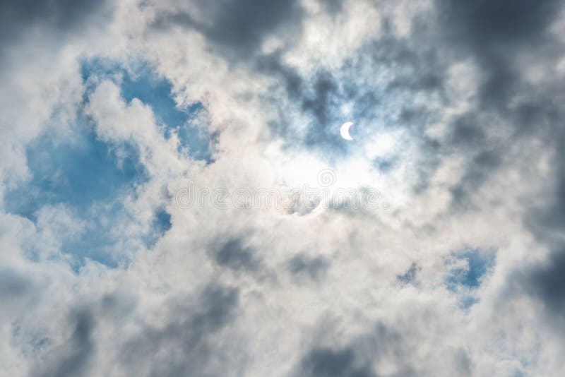 Solar Eclipse in Blue Sky among the Clouds Stock Image - Image of ...