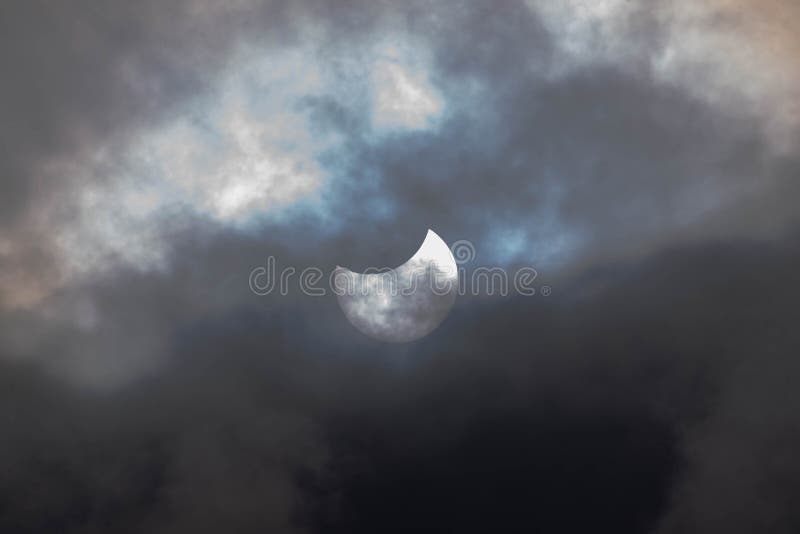 Solar Eclipse on a Cloudy Day. Stock Photo - Image of solar, eclipse ...