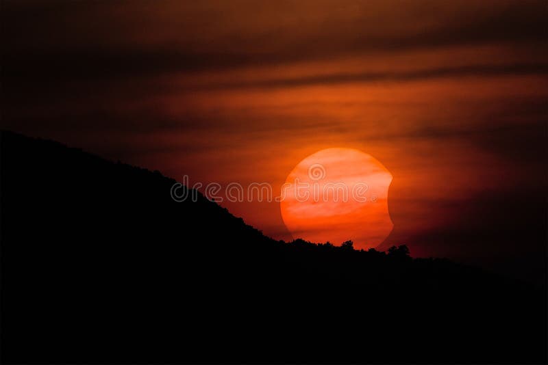 Solar eclipse in a sunset stock image. Image of celestial - 263379275