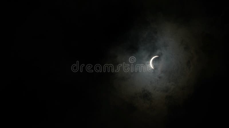 Solar Eclipse with the Moon Shining through Dark Clouds in Waco, Texas Stock Photo - Image of ...