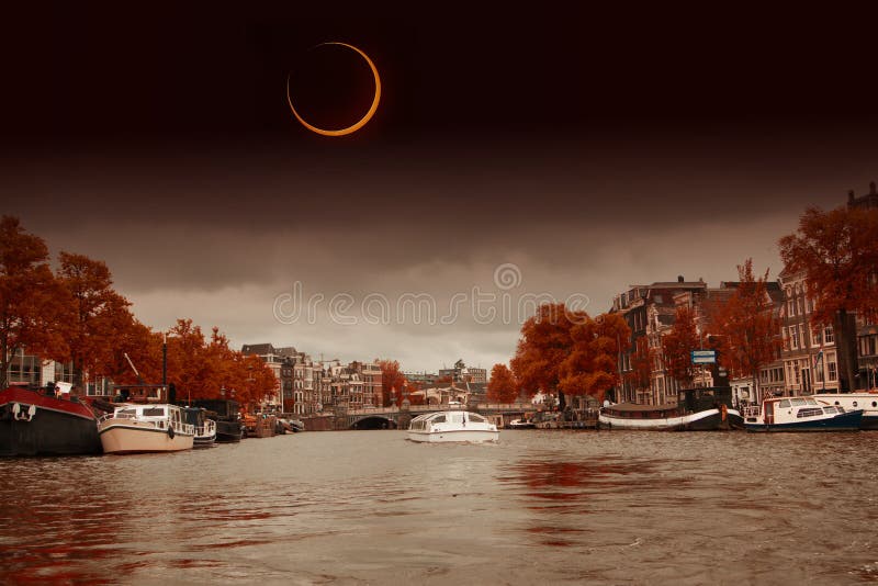 Total Solar Eclipse in Dark Red Glowing Sky Above Seaside City Stock ...