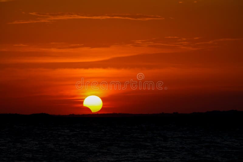 Solar Eclipse at Sunset Across the Sky Above the Sea Stock Image ...