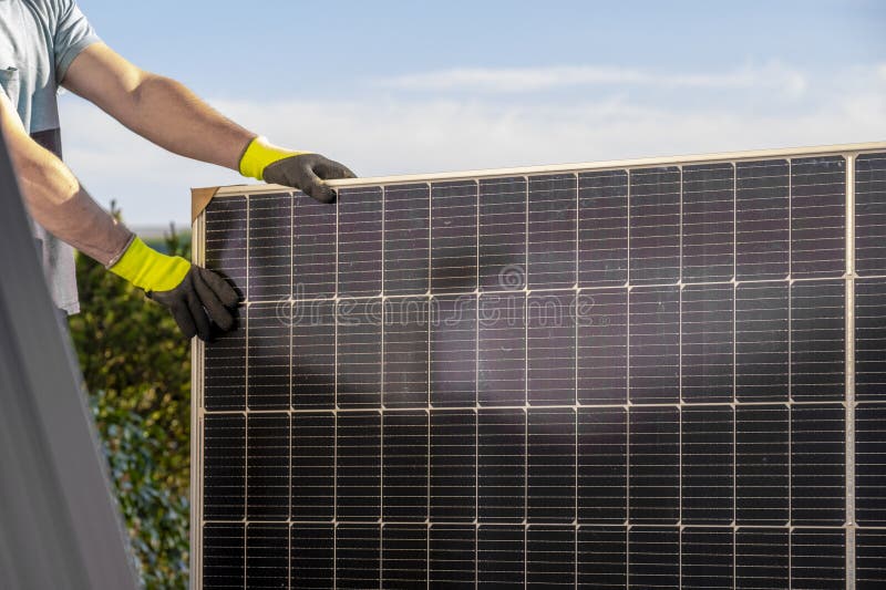 Solar Energy. Solar Panel in the Hands of a Worker .Installation of ...