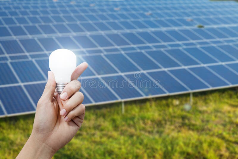 Solar Energy Panels and Light Bulb in Hand, Energy Stock Image - Image ...