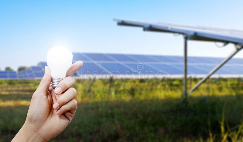 Solar Energy Panels and Light Bulb in Hand, Energy Stock Image - Image ...
