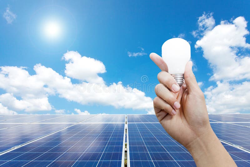 Solar Energy Panels and Light Bulb in Hand, Energy Stock Image - Image ...
