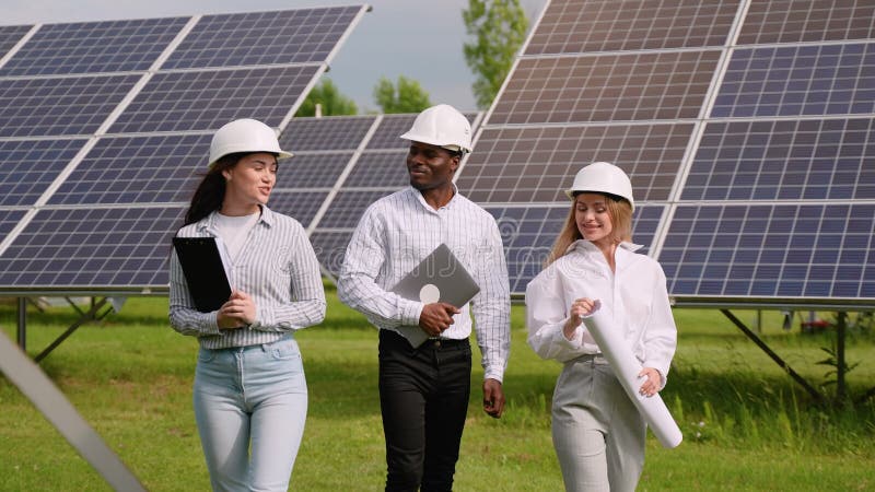 The Solar Farm with Three Engineers Walk To Check the Operation of the ...