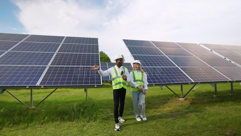 The Solar Farm with Two Engineers Walks To Check the Operation of the ...