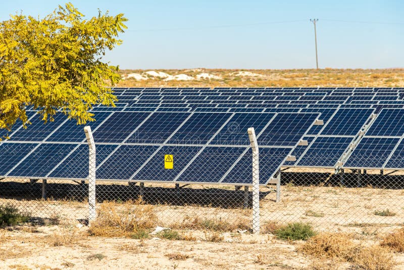Solar Field with Fenced Solar Panels at Sunset Stock Photo - Image of ...