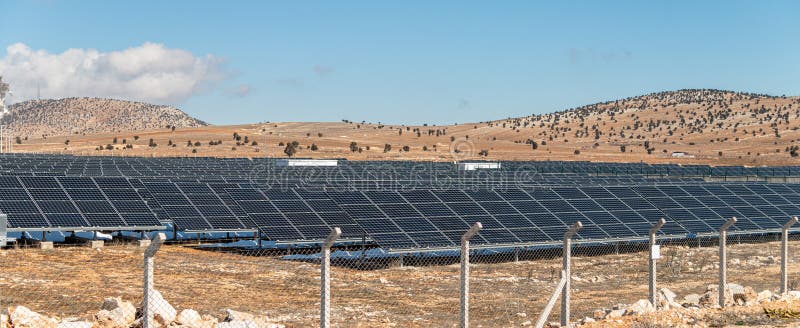 Solar Field with Fenced Solar Panels at Sunset Stock Image - Image of ...