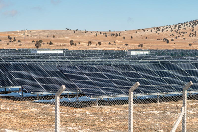 Solar Field with Fenced Solar Panels at Sunset Stock Photo - Image of ...