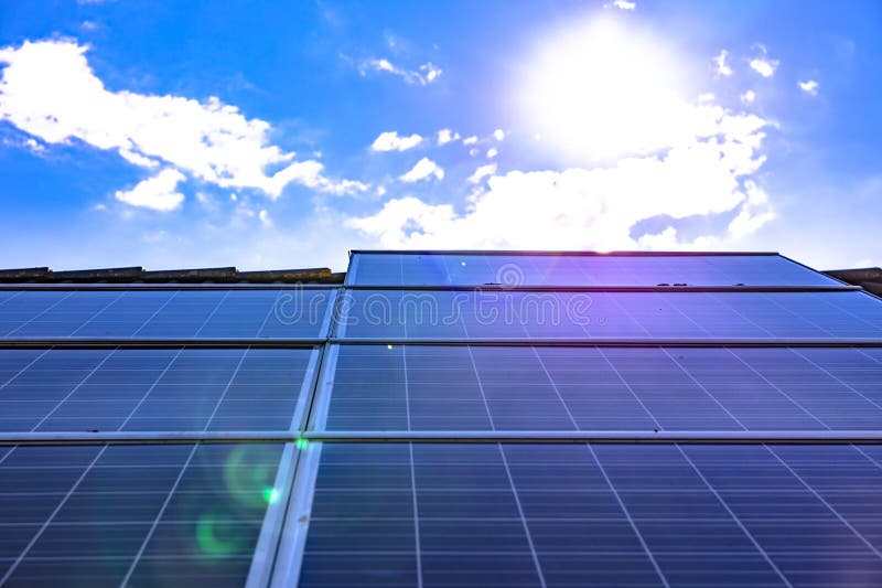 Solar Modules of a PV System on a Roof Against the Light Stock Image ...