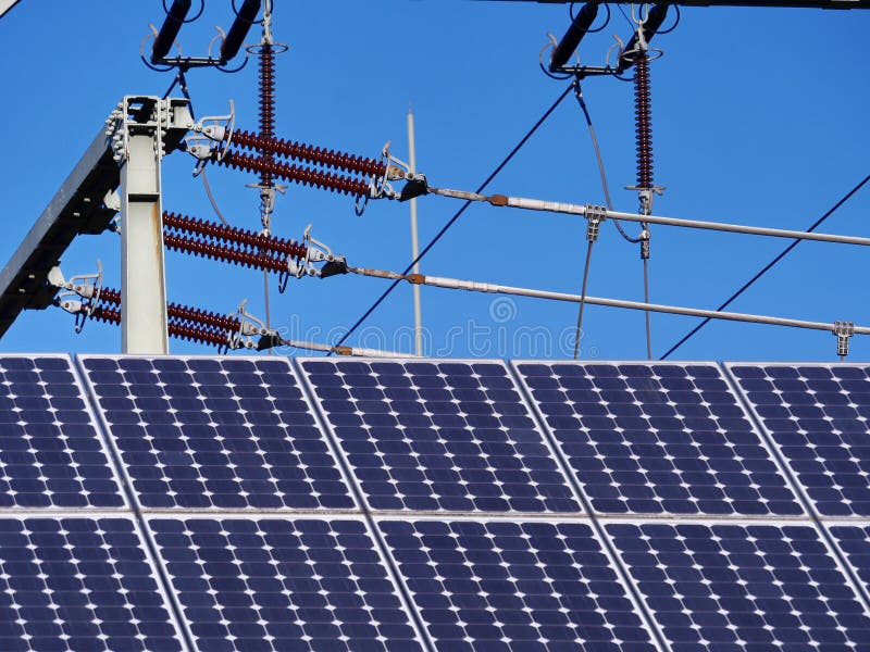 A Solar Panel Array is Shown with Wires and Power Lines Stock Photo ...