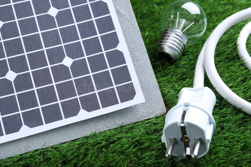 Solar Panel, Cable and Light Bulb on Grass, Closeup Stock Image - Image ...