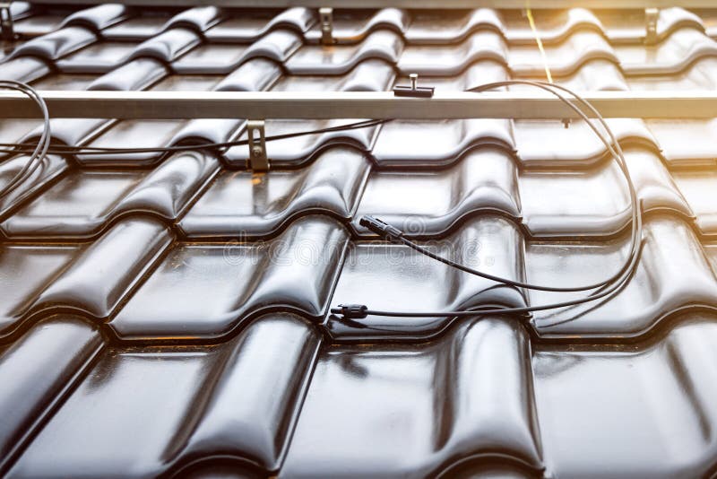 Solar Panel Cables and Mounting System on a Tiled Roof Stock Photo ...