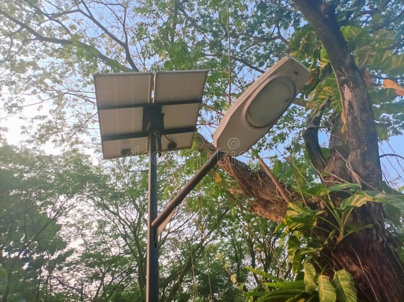 Solar Panel Device with Street Lamp on Background of Trees and Blue Sky ...