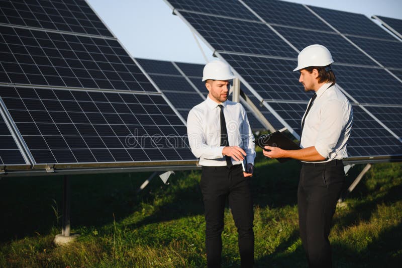 Solar Panel Farm. Two European Engineers Inspect Solar Panels Stock ...