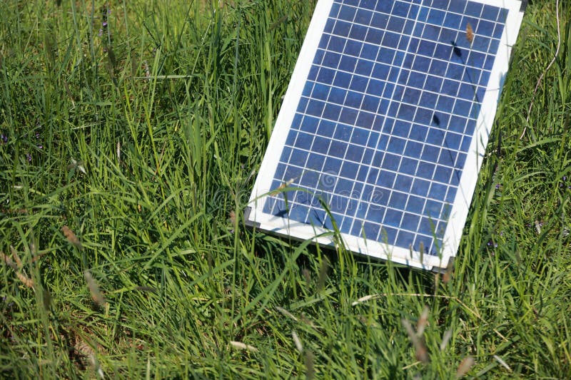 A Solar Panel is Laying on the Grass Stock Image - Image of environment ...