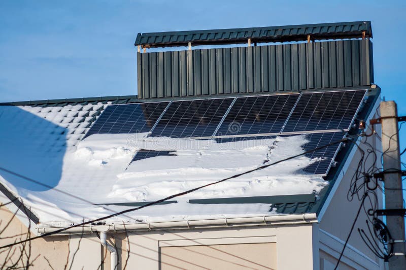 Solar Panel Modules are Mounted on the Roof of the House, Covered with ...