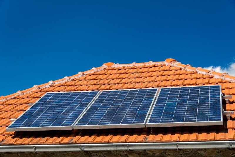 Solar panel on a red roof stock photo. Image of photovoltaic - 93724660
