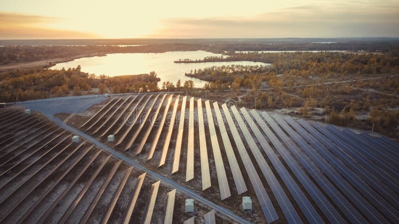 Solar Panel Station with Reflection of Sun and River on Background. ECO ...