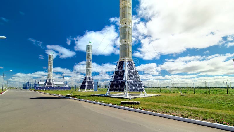 Solar Panel Towers on Solar Plant with High Voltage Tower in Background ...
