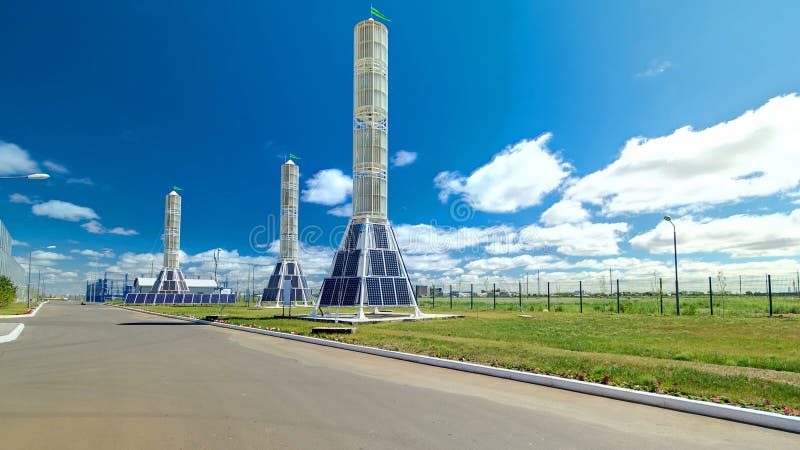 Solar Panel Towers on Solar Plant with High Voltage Tower in Background ...