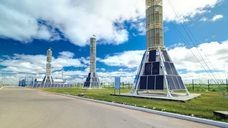 Solar Panel Towers on Solar Plant with High Voltage Tower in Background ...