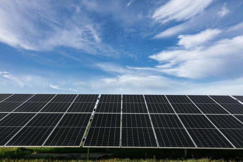 Solar Panels Absorbing Sunlight Under a Cloudy Blue Sky Stock Image ...