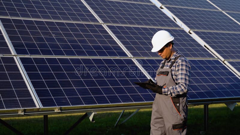 Indian Electrical Engineer Holding Digital Tablet with Solar Panels ...