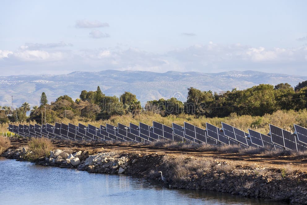 Solar Panels Lining a Canal with Mountains Stock Image - Image of ...