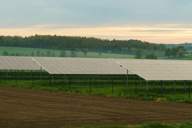 Solar Panels of a Power Plant on a Green Field Stock Photo - Image of ...