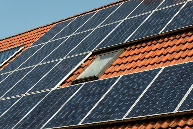 Solar panels on a red roof stock image. Image of energy - 58256411