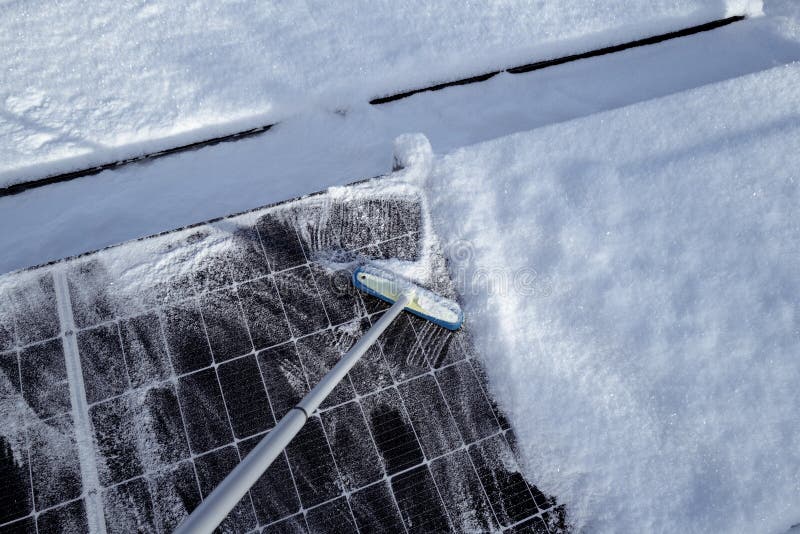 Solar Panels on the Roof are Cleaned from Snow with the Broom Stock ...