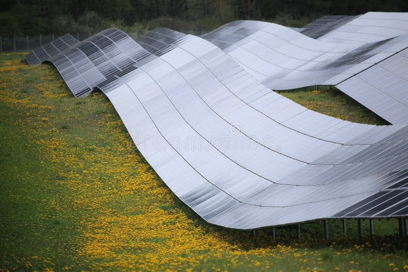 Solar Panels on a Wavy Grass Landscape Stock Photo - Image of curled ...
