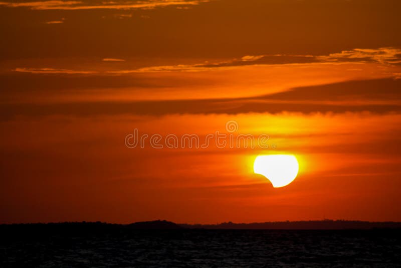 Solar Partly Eclipse at Sunset Stock Photo - Image of horizon, glow ...