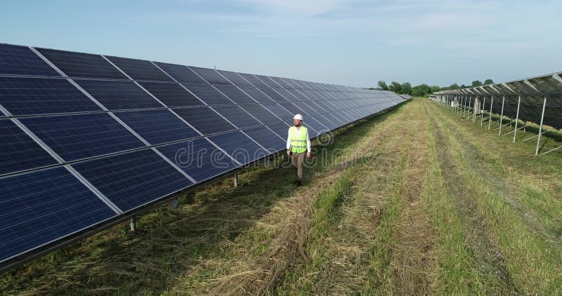 Solar Power Engineer Working on a Solar Farm. Drone Shot Stock Image ...