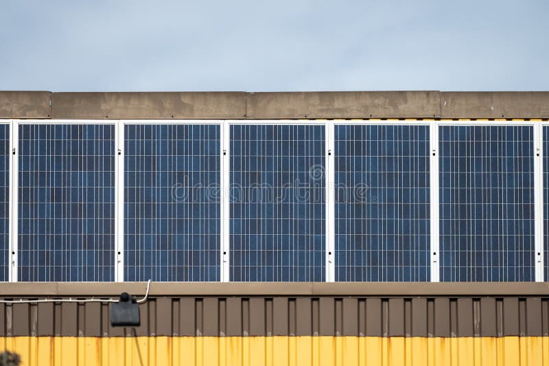 Solar Power Panels on the Facade of a Yellow Warehouse.. Stock Image ...