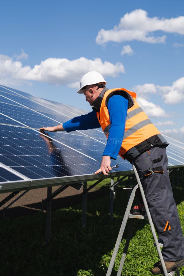 Solar Power Plant Worker on Stepladder Makes a Visual Inspection of ...