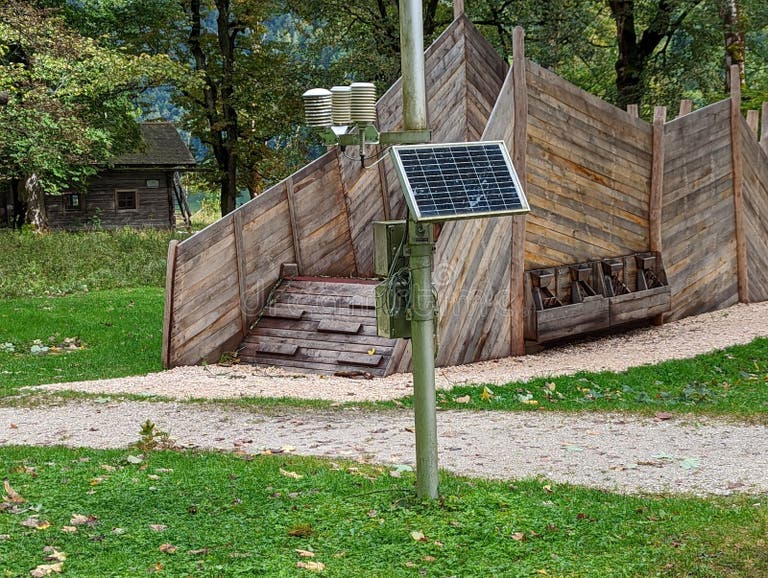 Solar Powered Weather Station in Front of Playground with Hut and Path ...