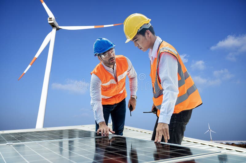 Solar and Wind Farm Renewable Energy. Foreman and Worker Maintaining ...