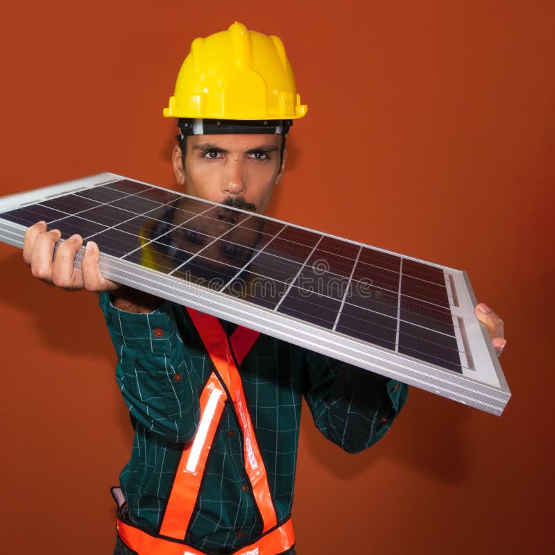 Solar Worker in Protective Work Looking on Focus Photovoltaic Panel ...